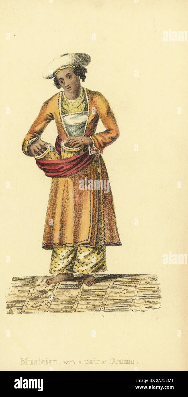 Indian musician with pair of tabla drums in his waist sash ...