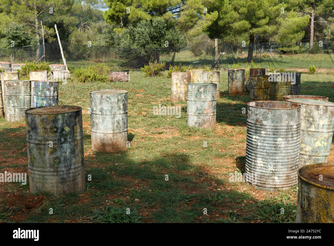 Empty open playground for paintball with barrels used by players as ...