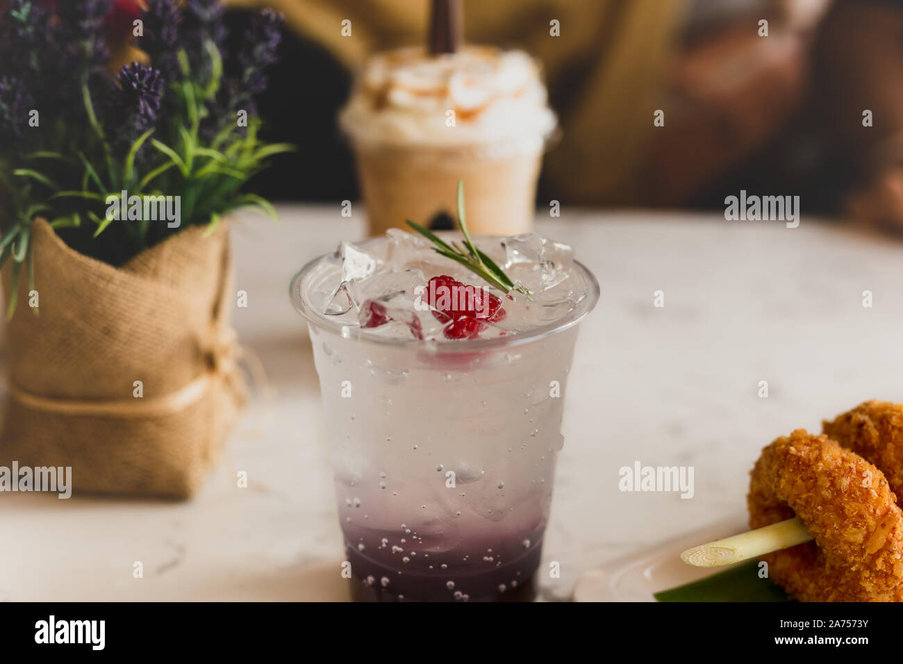 Refreshing red translucent drinks with ice and raspberries Stock Photo ...
