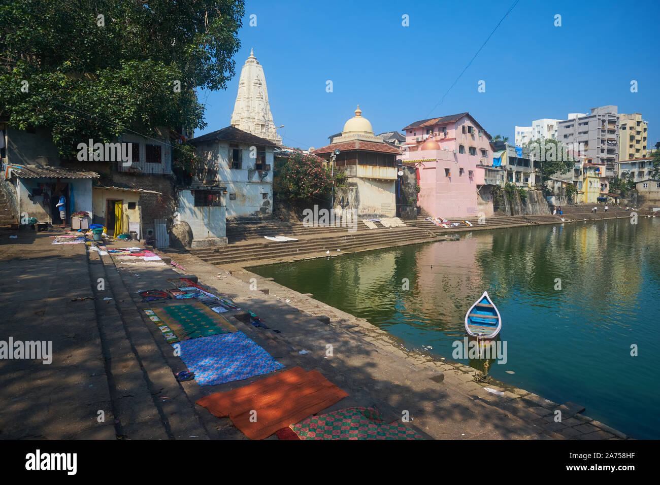 A small rowing boat is anchored in Banganga Tank, a sacred Hindu spot ...