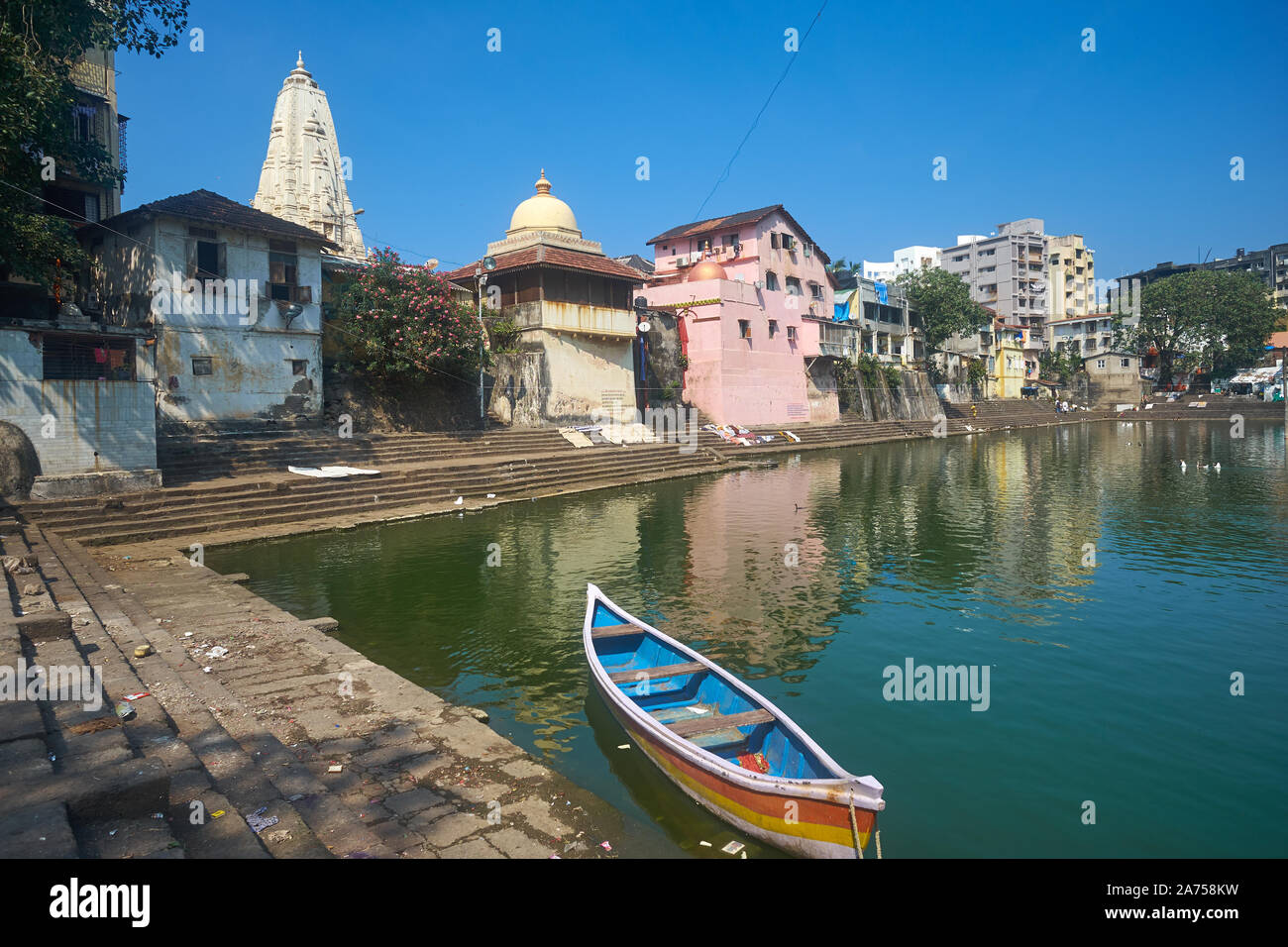 A small rowing boat is anchored in Banganga Tank, a sacred Hindu spot ...