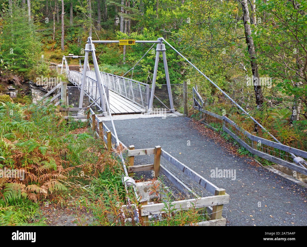 A view of the Victorian suspension bridge over the Corrieshalloch Gorge ...