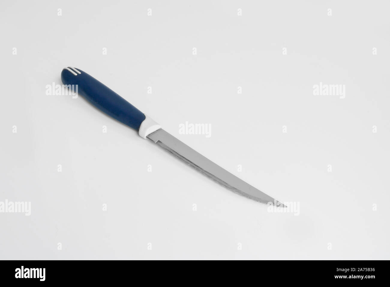 Kitchen utensils - a universal knife with a saw on a light background ...