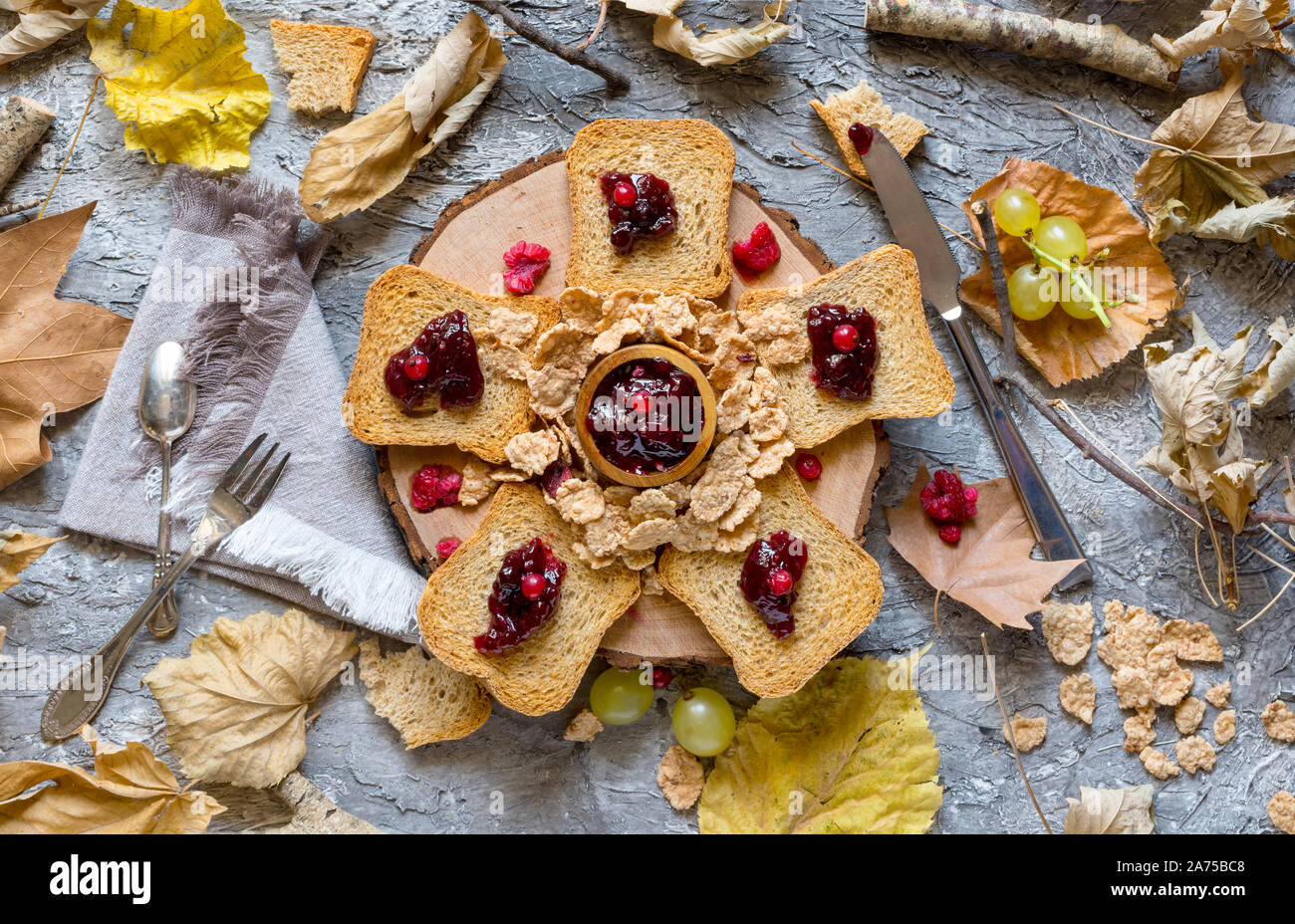 autumnal food background with rusks and wildberries jam Stock Photo - Alamy