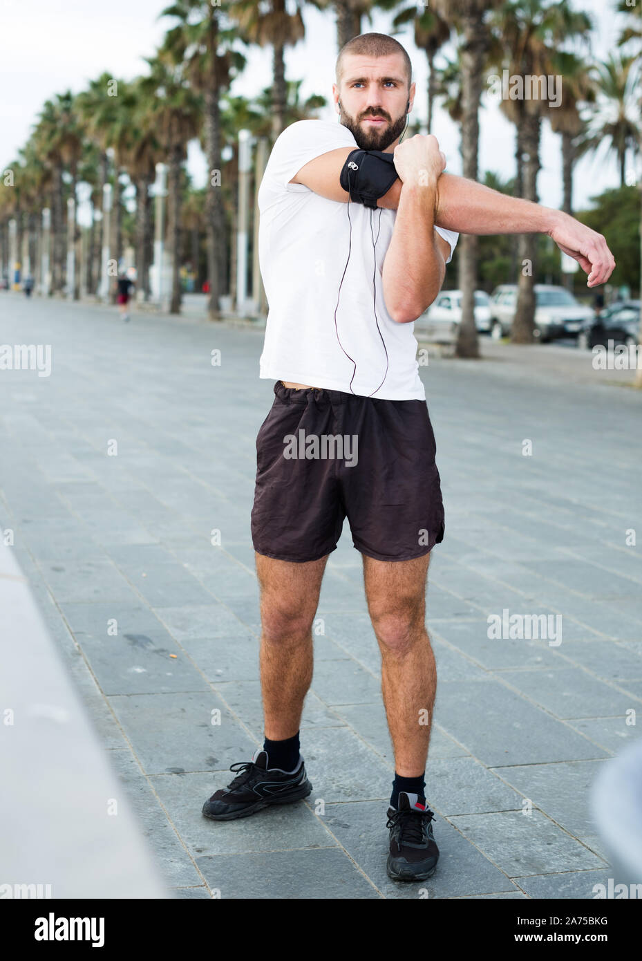 Young man warming up before a workout or run Stock Photo - Alamy