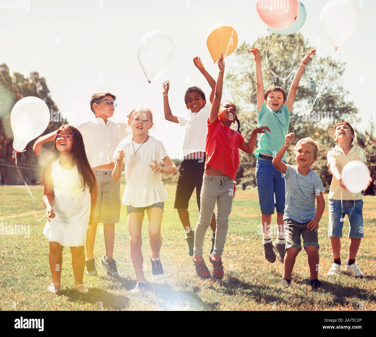 Kids playing balloons on field hi-res stock photography and images - Alamy