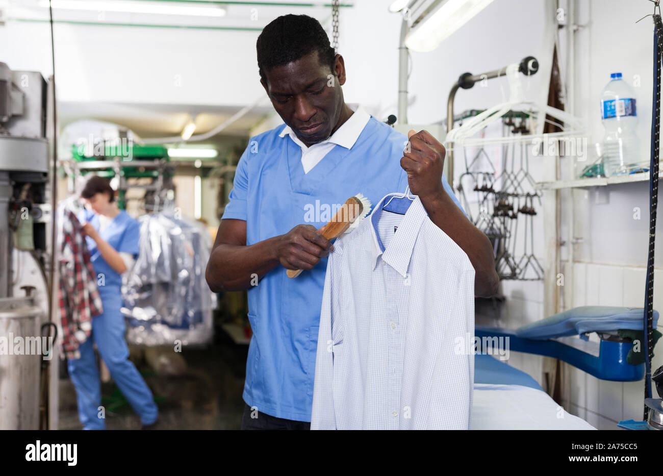Portrait of skilled African male laundry worker during daily work Stock ...