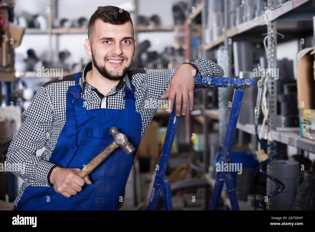 Male builder showing his constructing tools at workspace Stock Photo ...