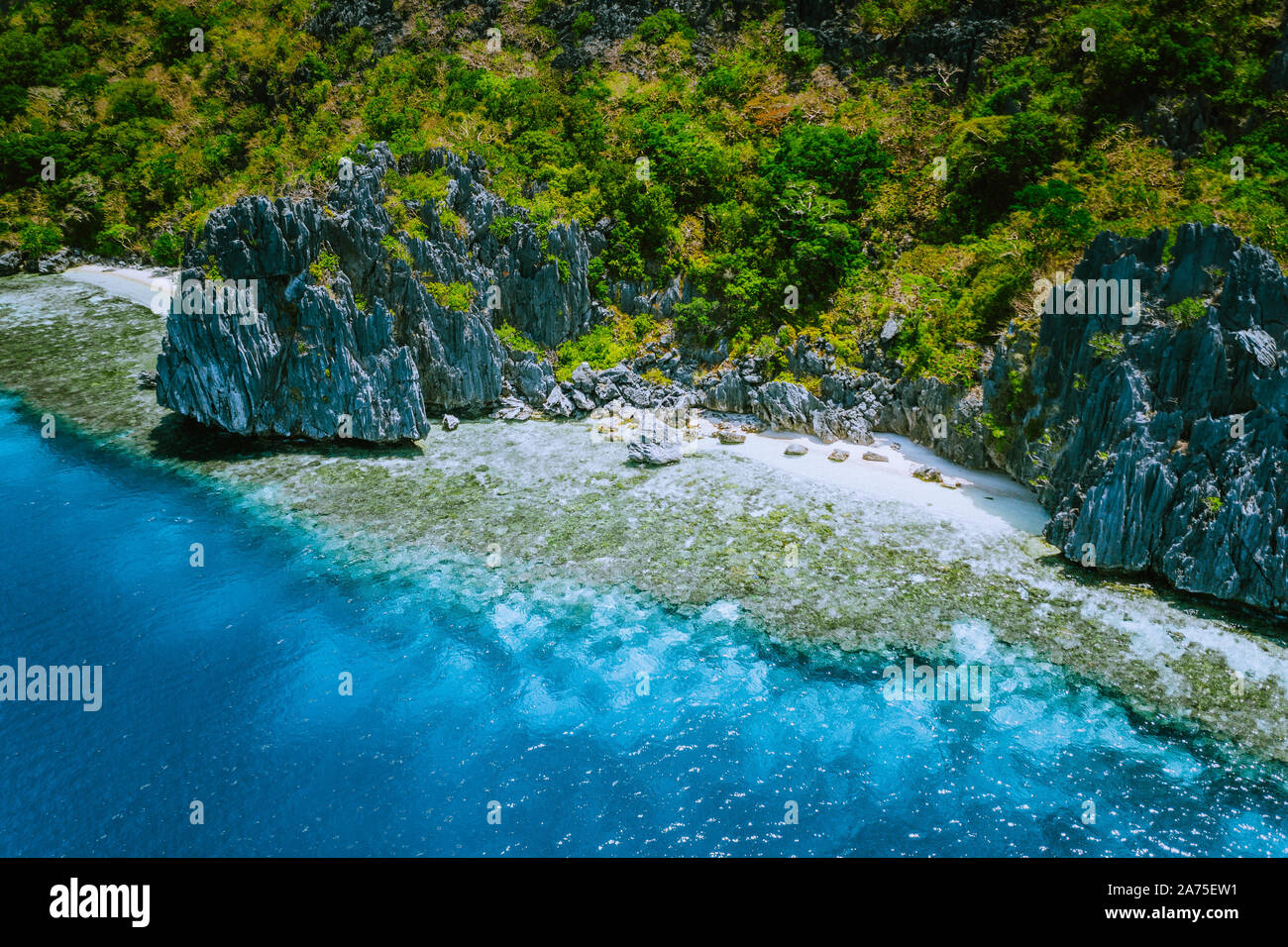 Aerial view of beautiful tropical limestone rocks, blue ocean and coral ...