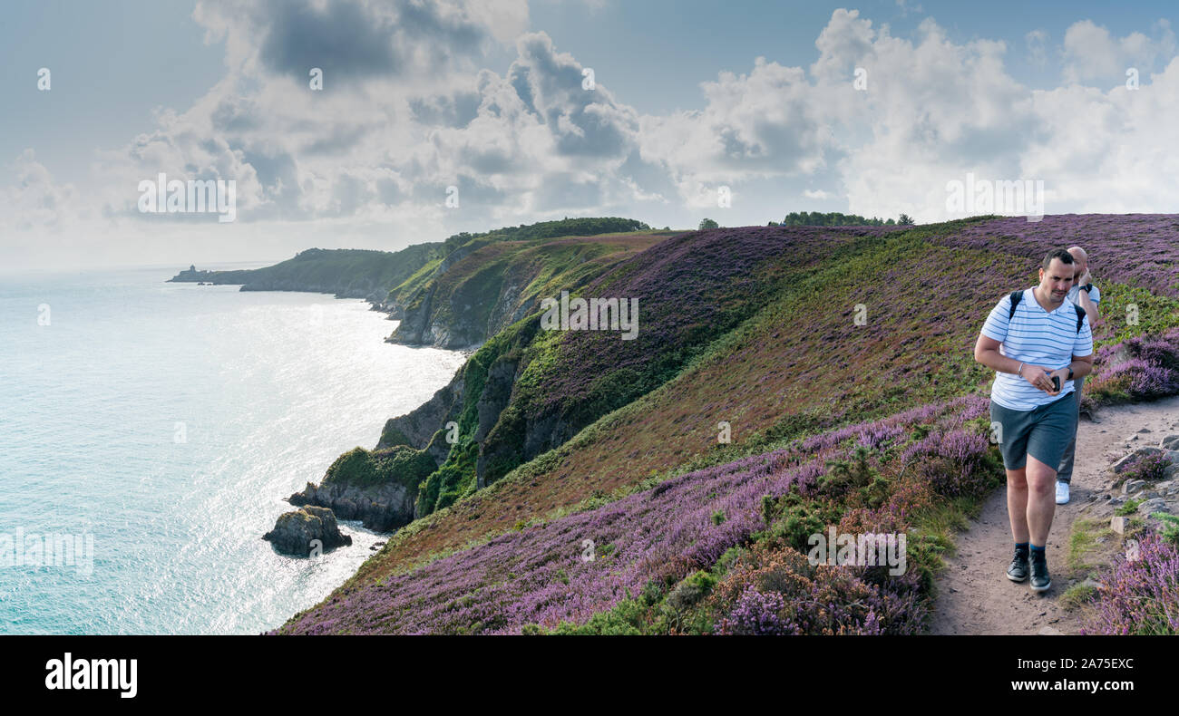 Plevenon, Bretagne / France - 20 Augsut 2019: men hiking along a trail ...