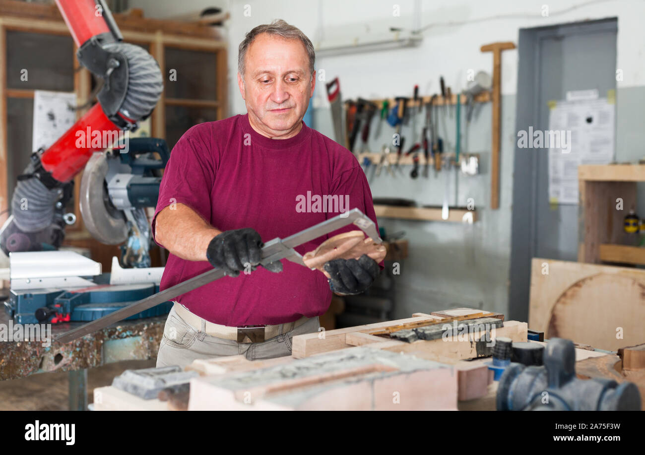 Foreman checks 3d model with a caliper Stock Photo - Alamy