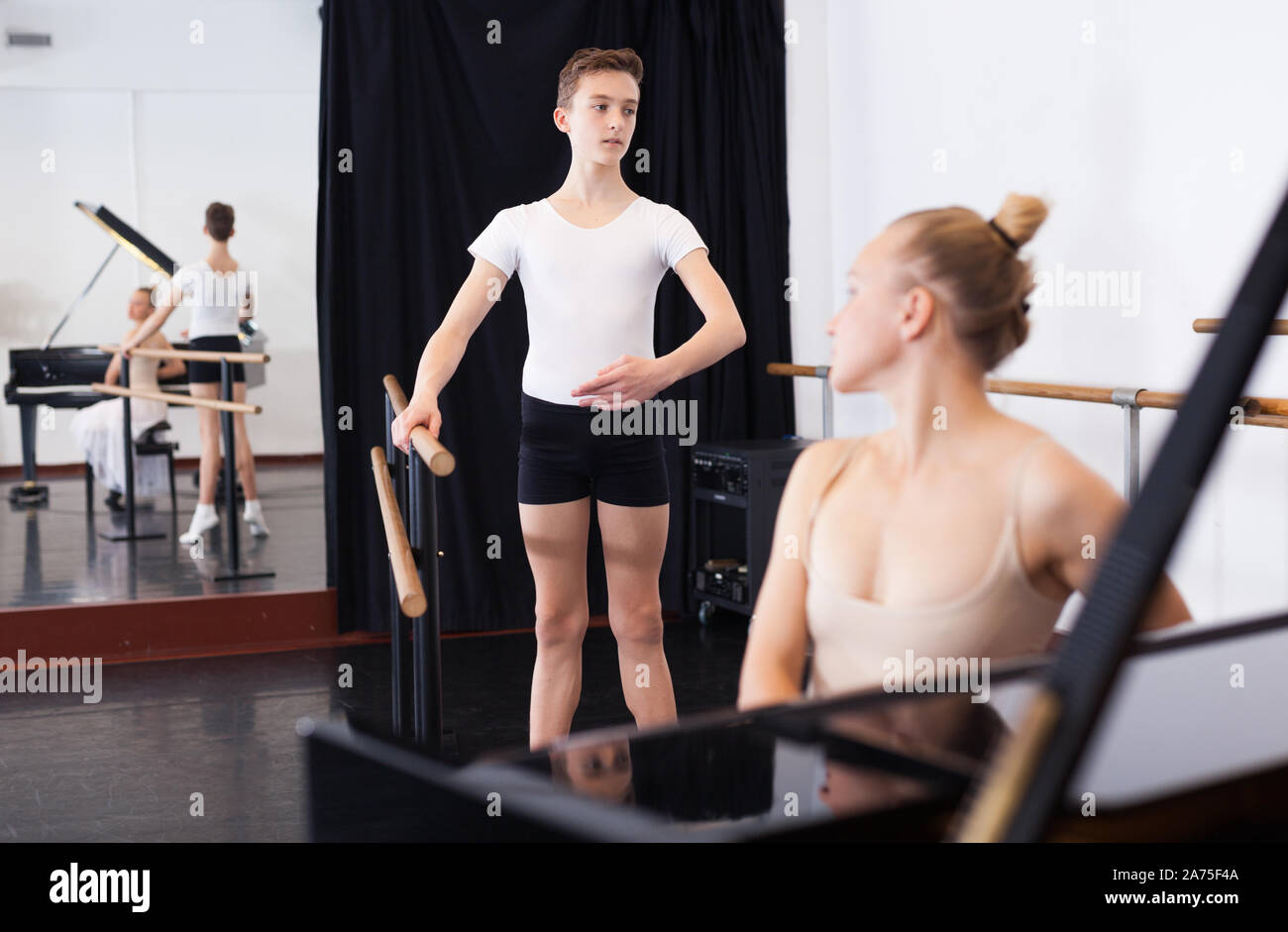 Ballet lesson in the studio. Choreographer plays the piano Stock Photo ...