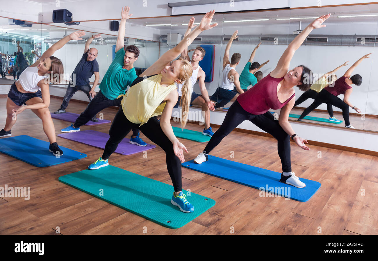 Active people training on mates at the fitness school Stock Photo - Alamy