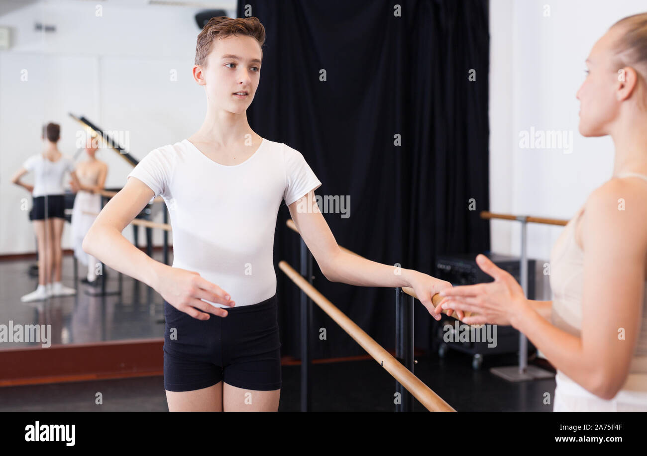 Choreographer helping young man dancer to have right position ...