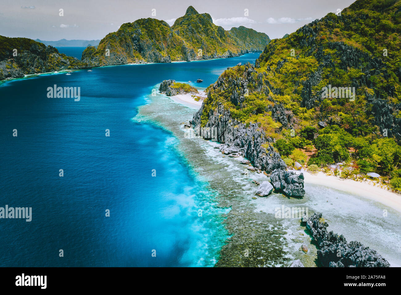Aerial view of jutted lime stone cliff karst mountains on island tour ...