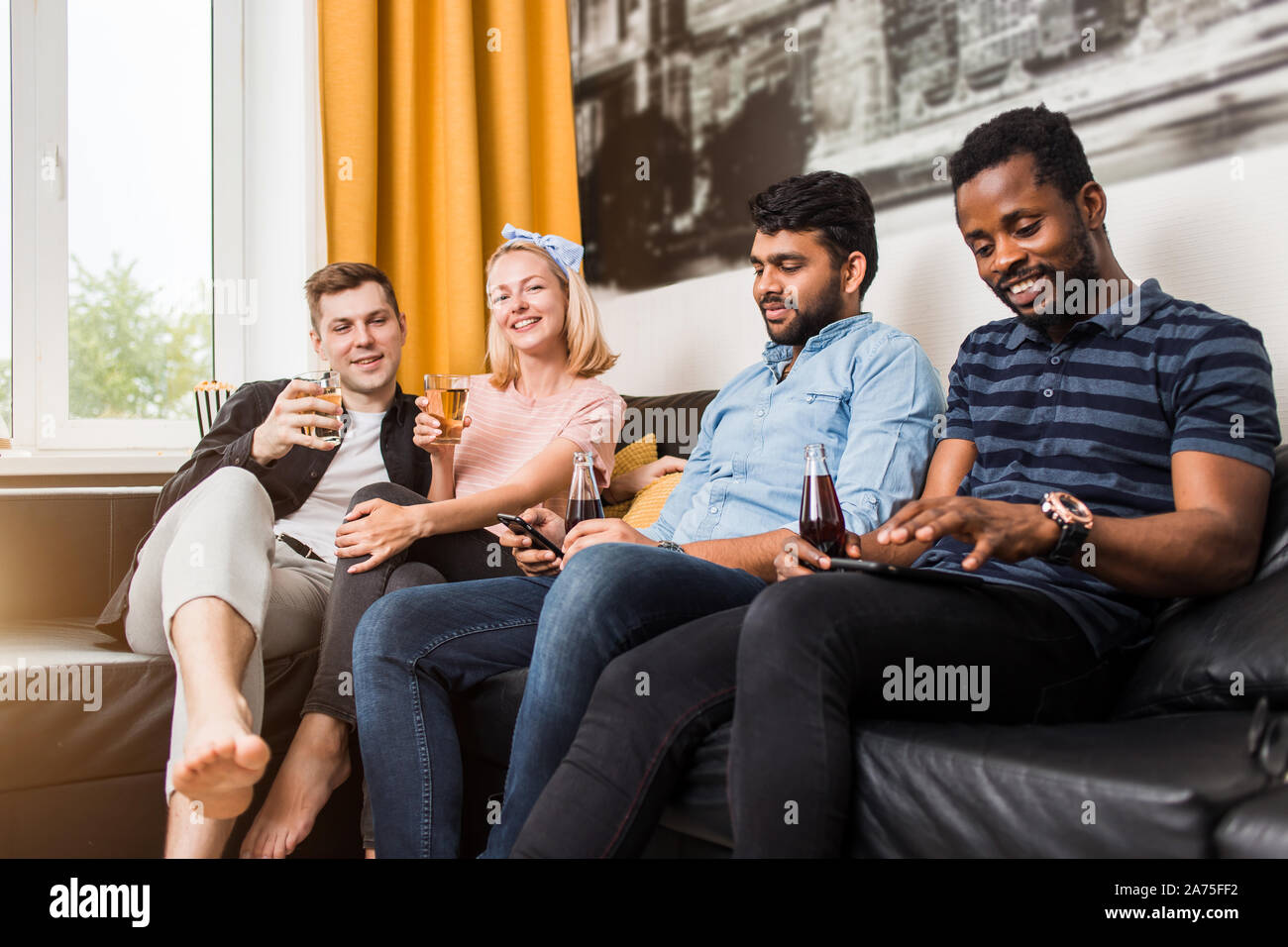 Friendship, entertainment concept. Shot of four happy friends sitting ...
