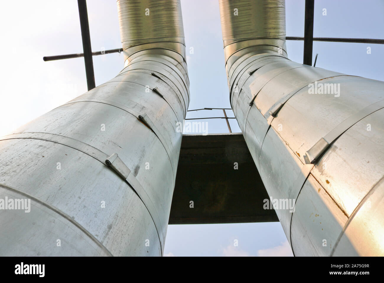 Two large pipes upholstered with stainless steel sheets on the street ...