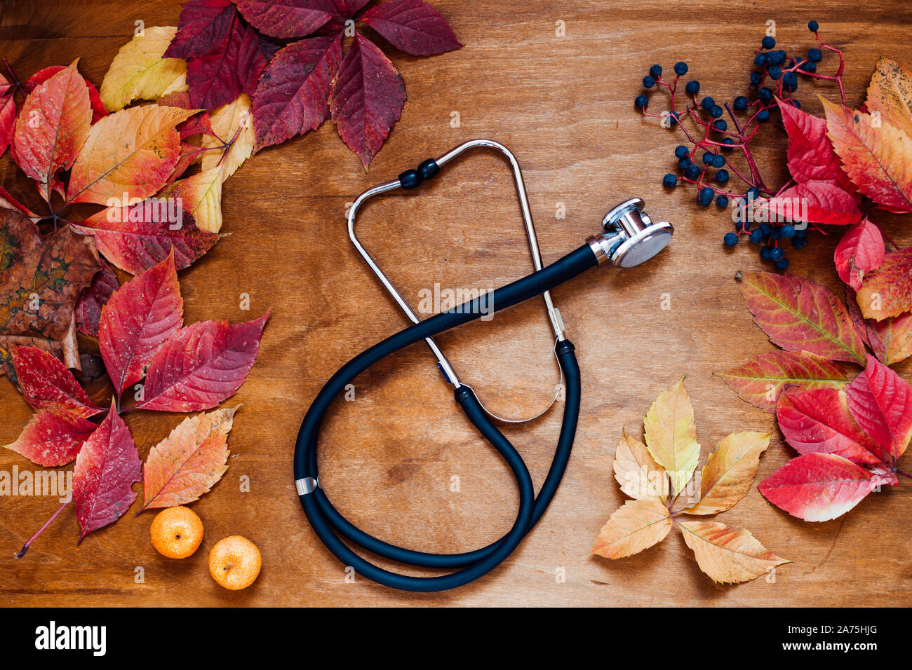 colorful leaves on wooden background medical stethoscope Stock Photo ...