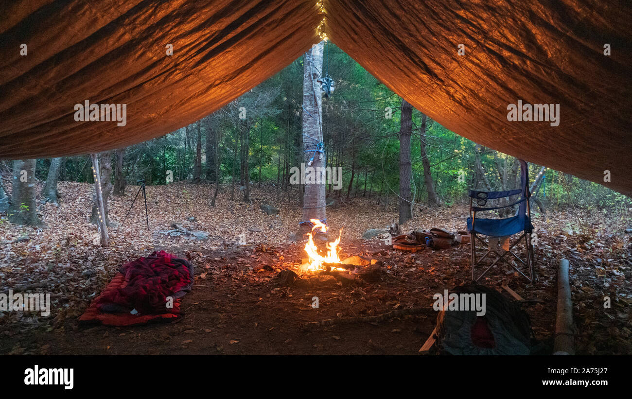 Primitive Tarp Shelter with campfire and fairy lights. Survival ...