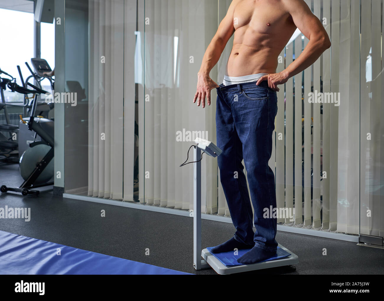 thin man stands on the scales Stock Photo - Alamy