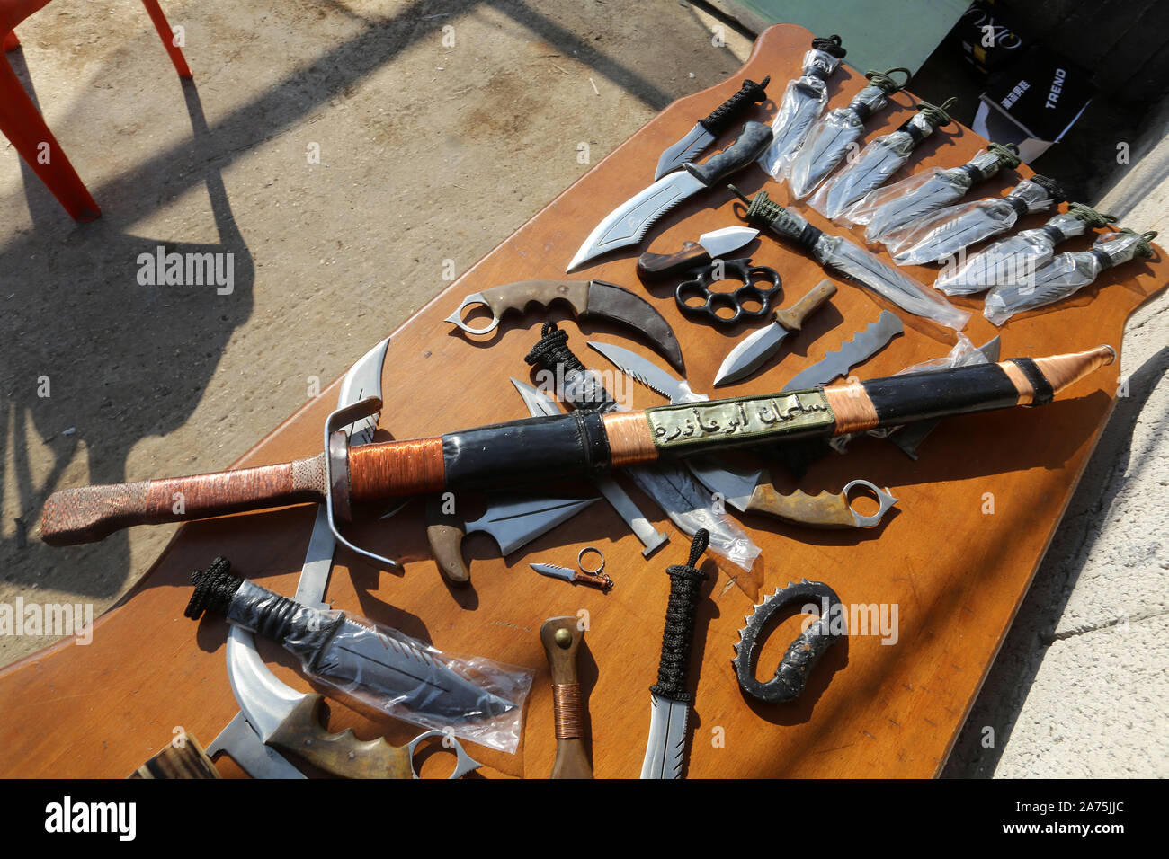 A Palestinian man Saif Abu Adra, makes daggers and swords in his small ...