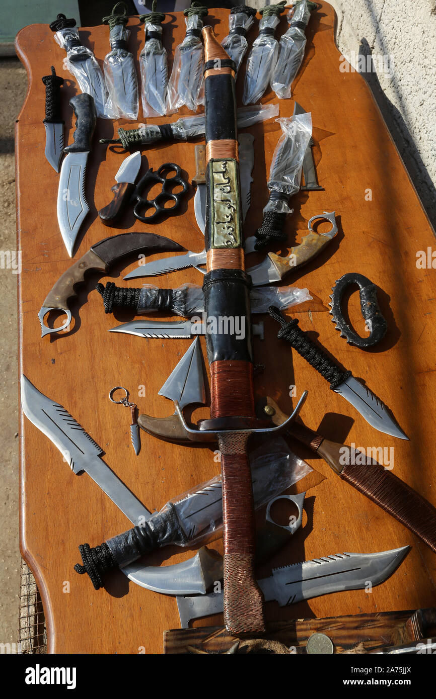 A Palestinian man Saif Abu Adra, makes daggers and swords in his small ...