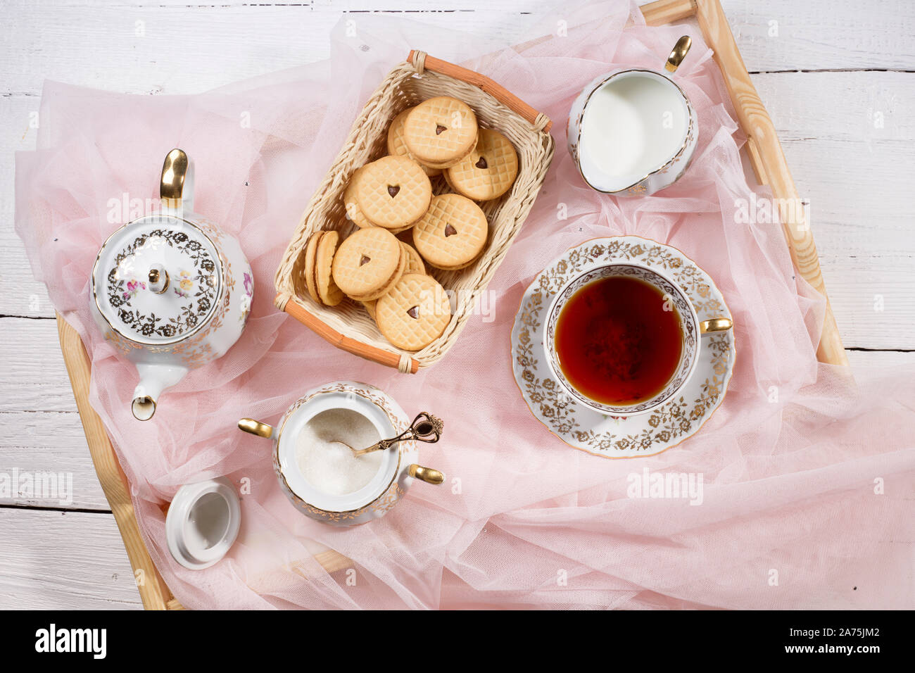 Morning tea concept with cup of tea, teapot and biscuit Stock Photo - Alamy