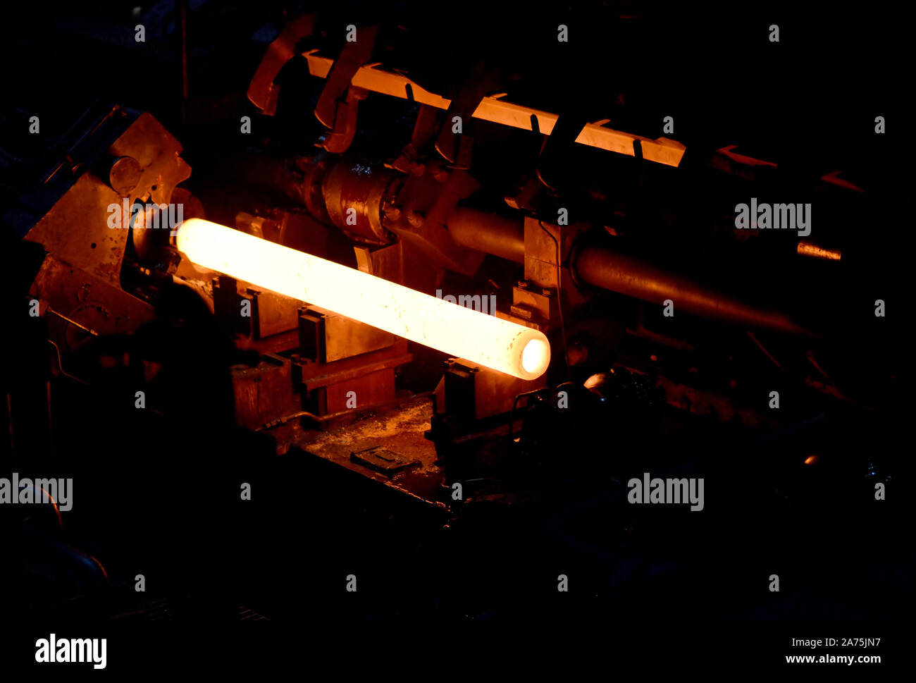 glowing steel tube during production in a modern rolling mill in the ...