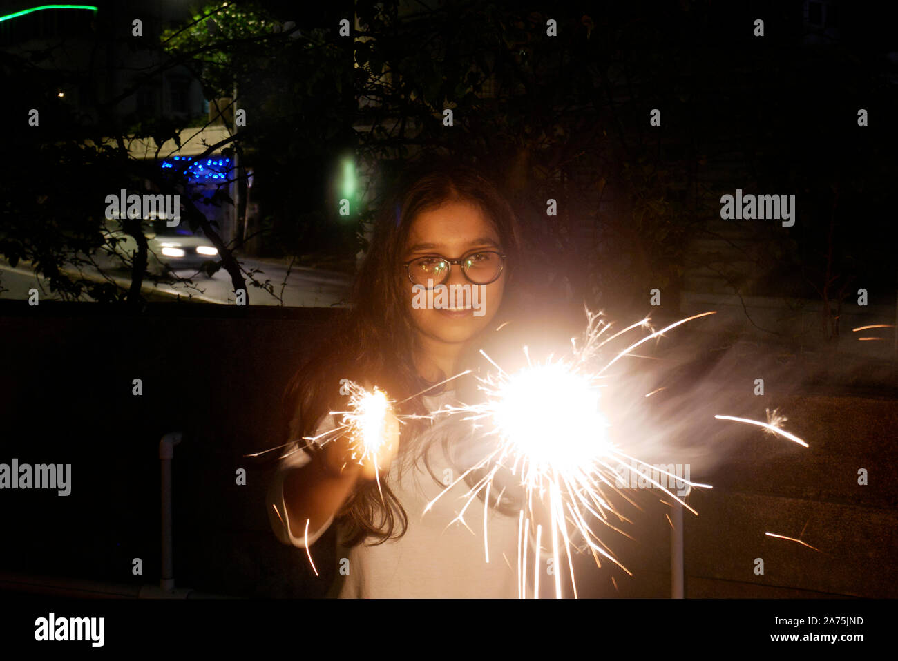 YOUNG WOMAN BURSTING FIRECRACKERS DURING DIWALI IN MUMBAI Stock Photo ...