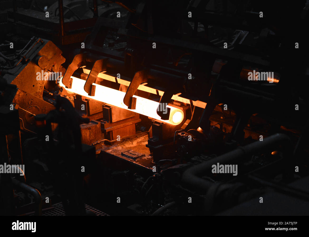 glowing steel tube during production in a modern rolling mill in the ...