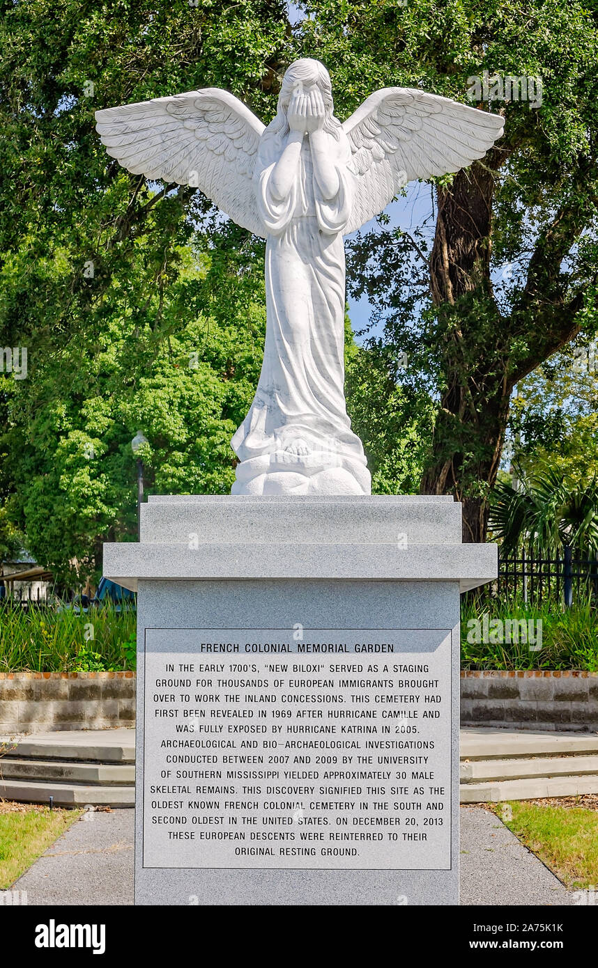An angel stands with her face covered in the French Colonial Memorial ...