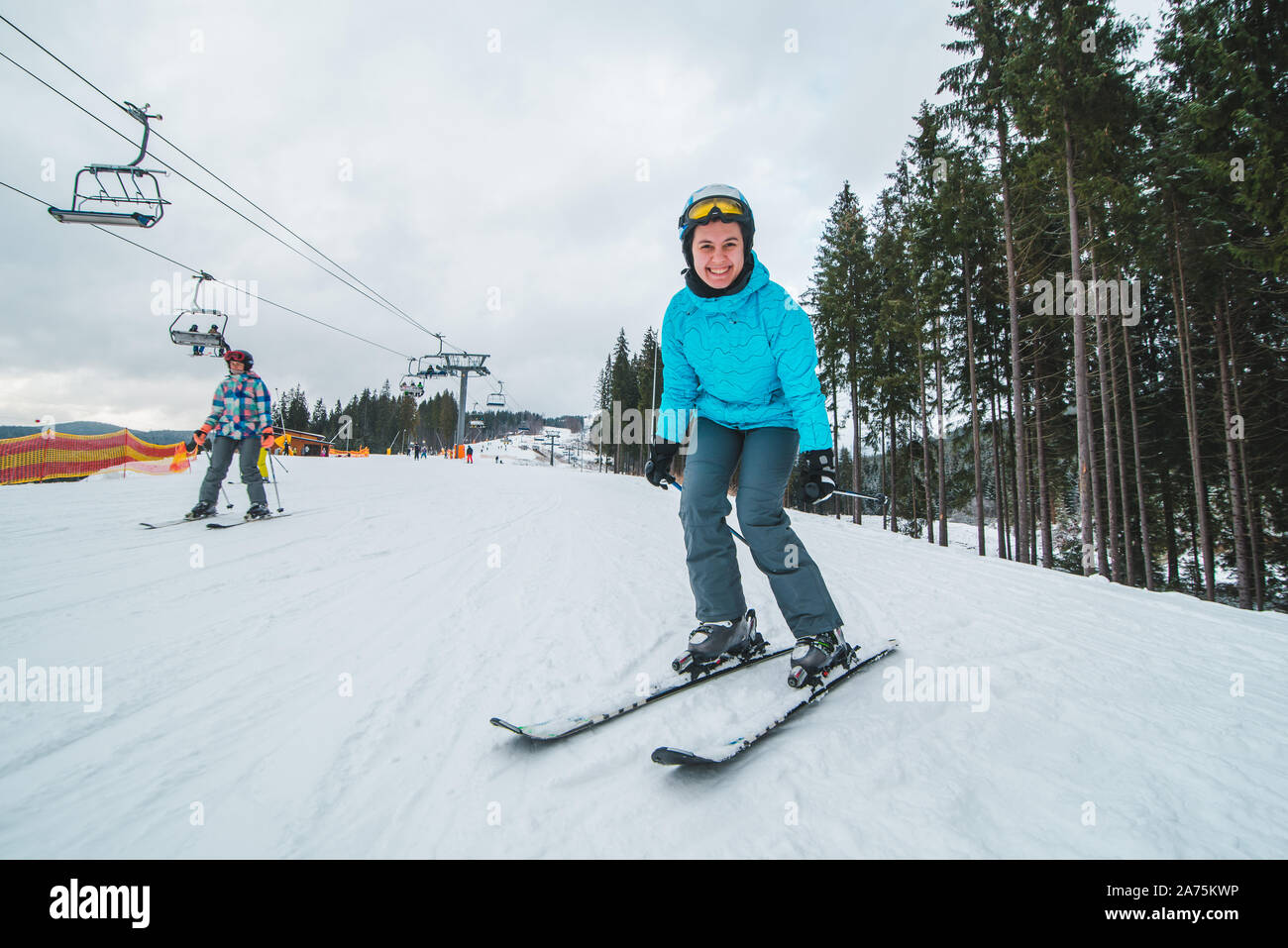 wide angel picture of skiing young adult woman Stock Photo - Alamy