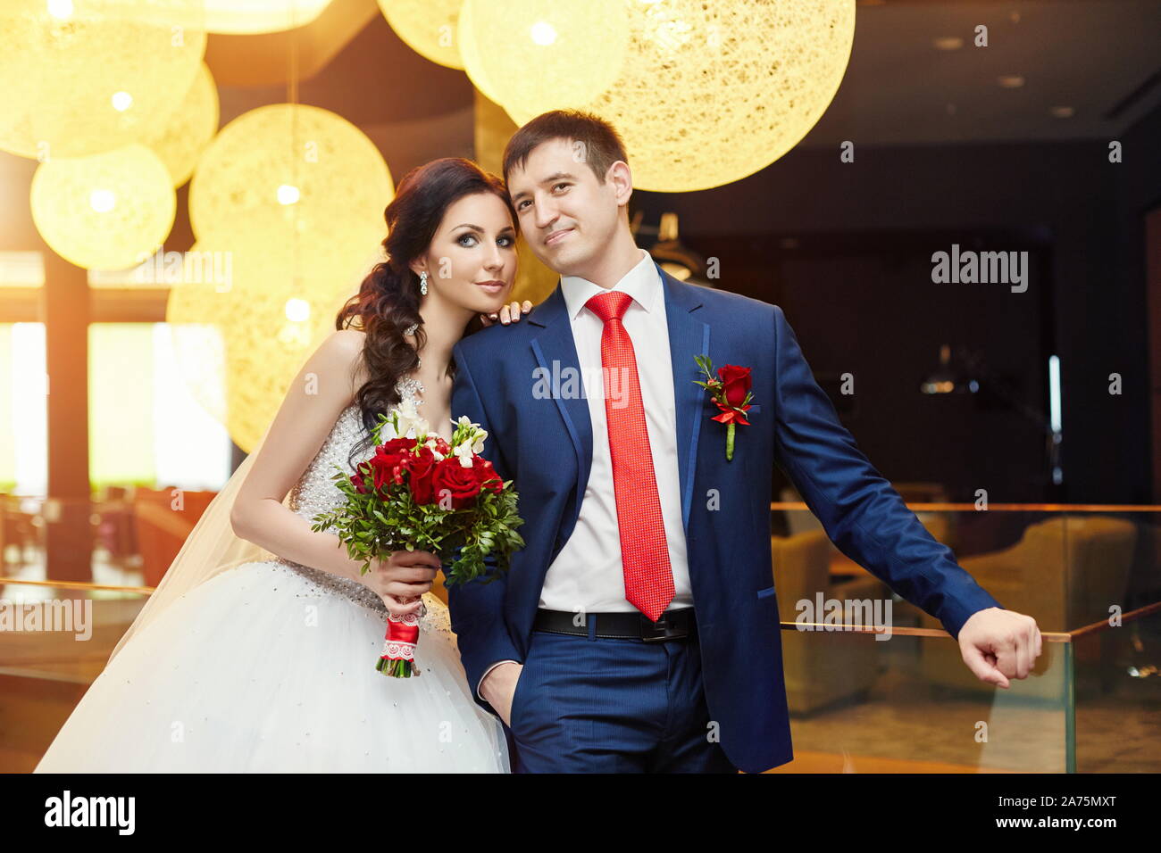 Portrait of the bride and groom in the wedding hall. Loving couple ...