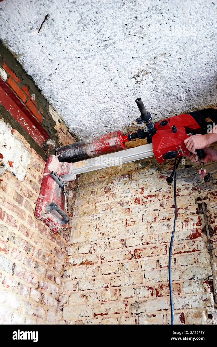 Professional laborer pierce a big round hole in a brick wall Stock ...