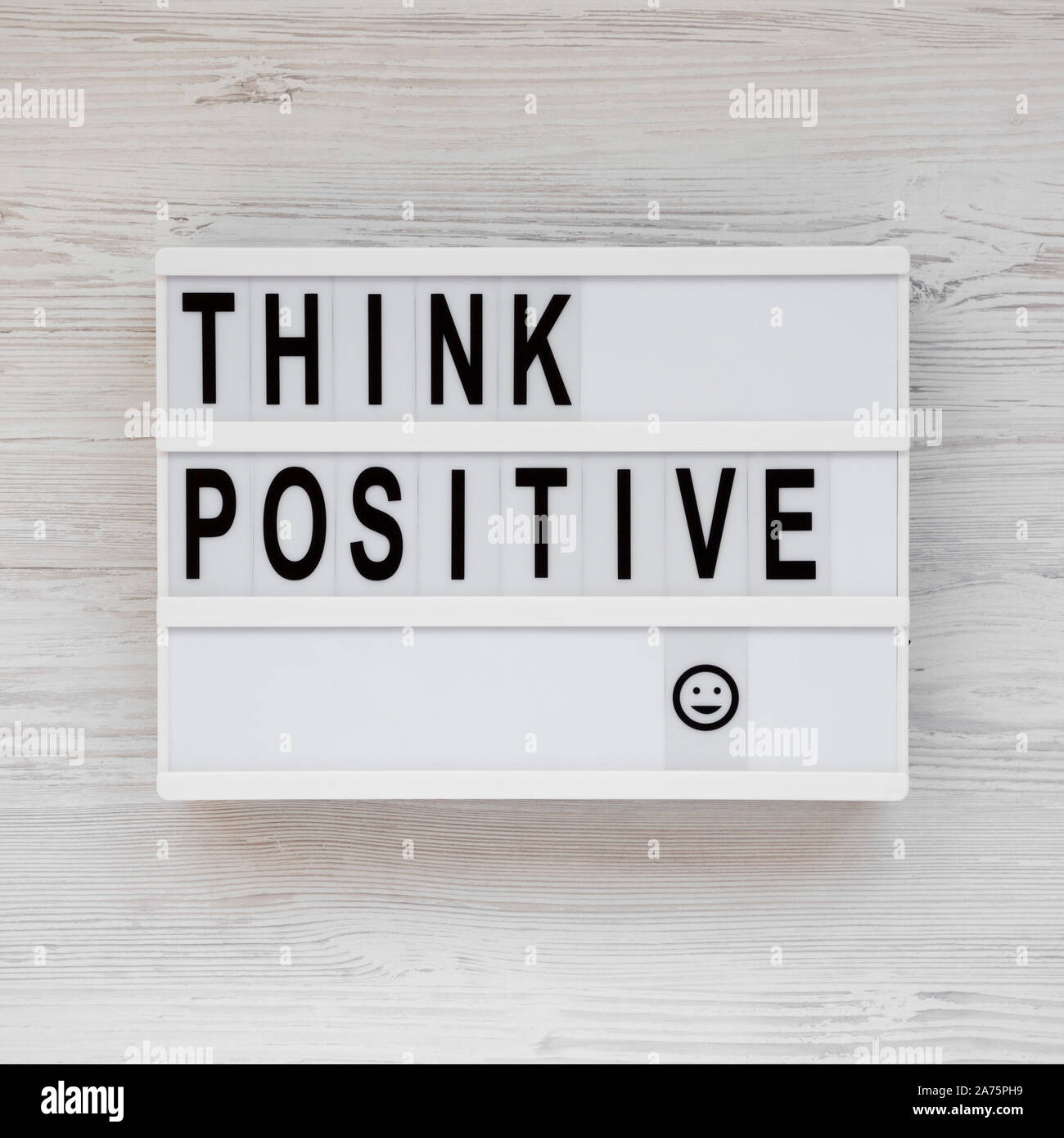 'Think positive' words on a modern board, clipboard with blank sheet of ...