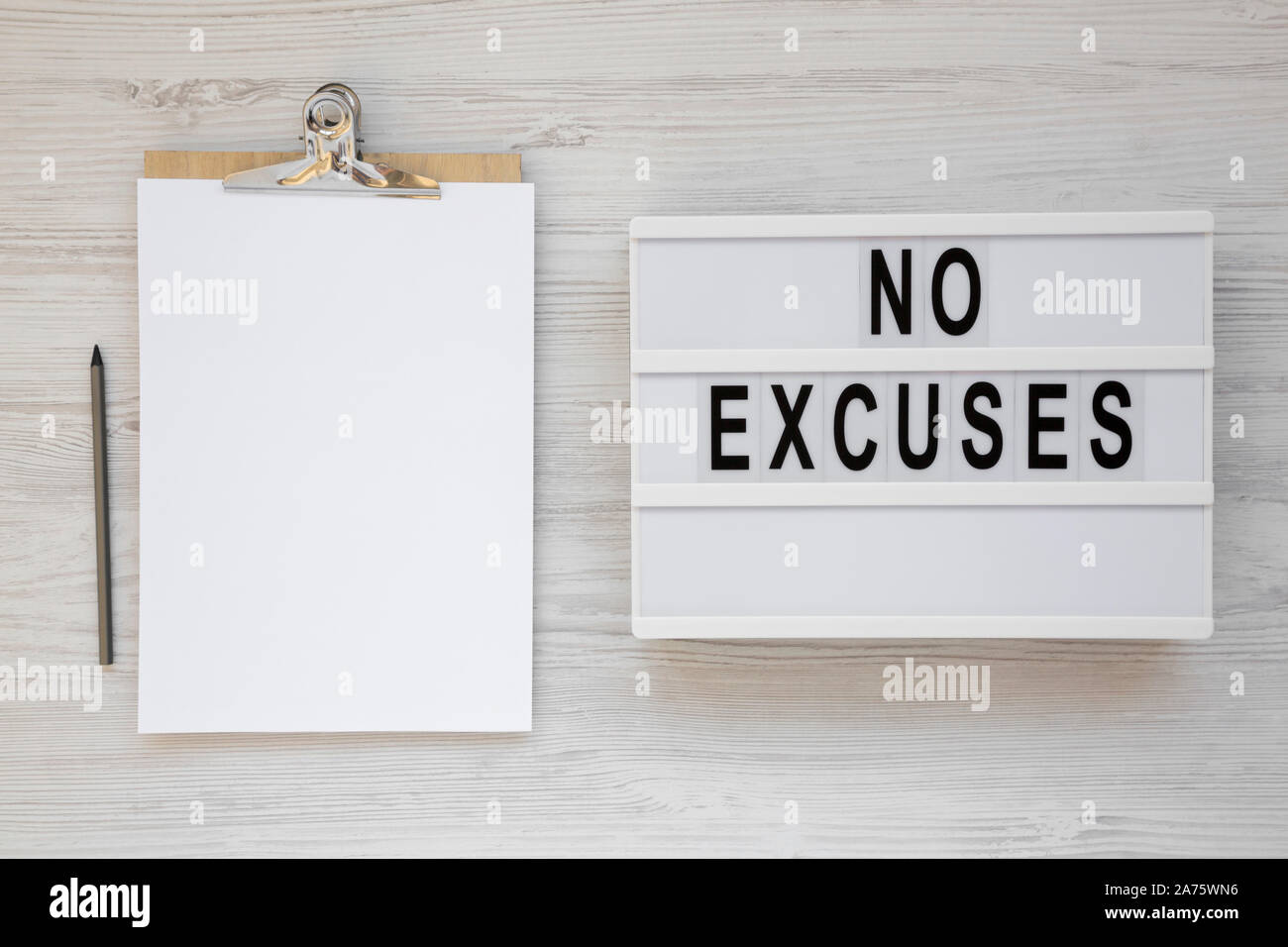 'No excuses' words on a modern board on a white wooden background, top ...