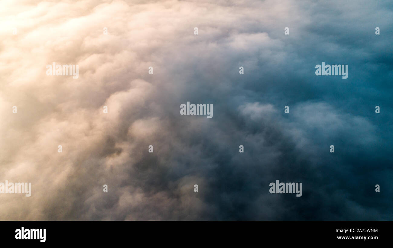 Background from thick morning blue fog with warm backlight from the ...
