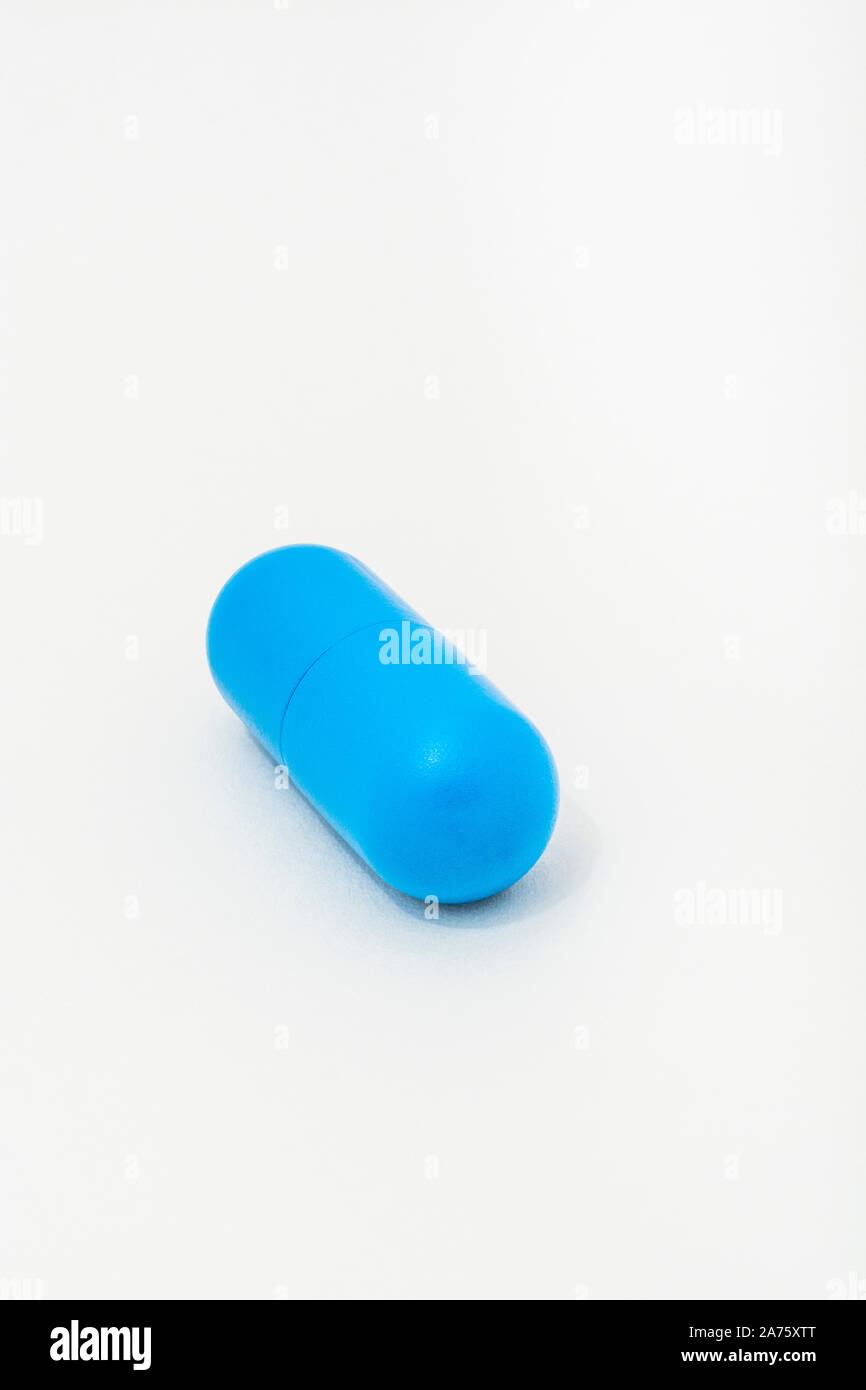 Blue capsule on plain background. Medicare, NHS / National Health ...