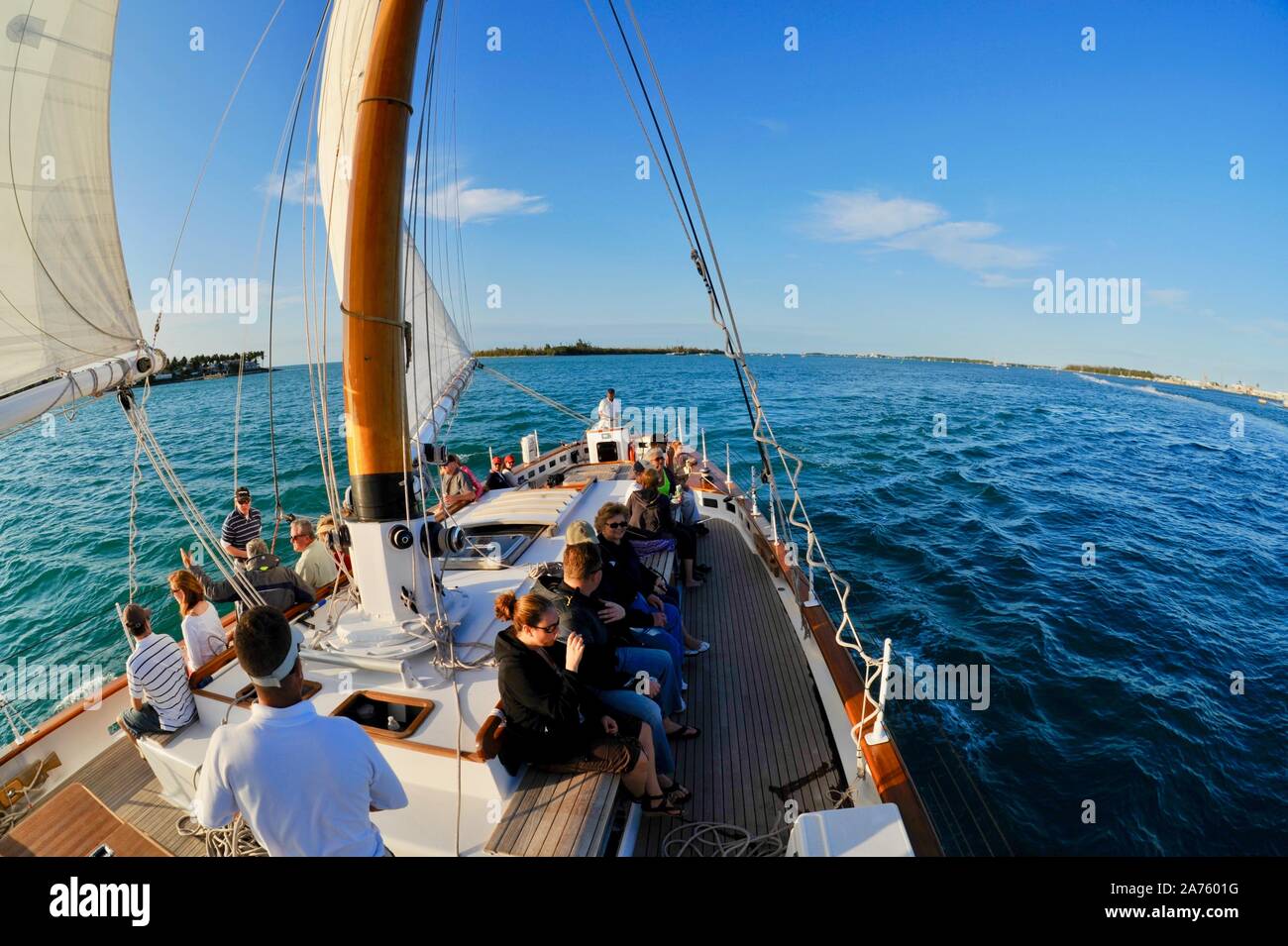 Passengers enjoying cruise on Schooner America 2.0 plying turquoise ...