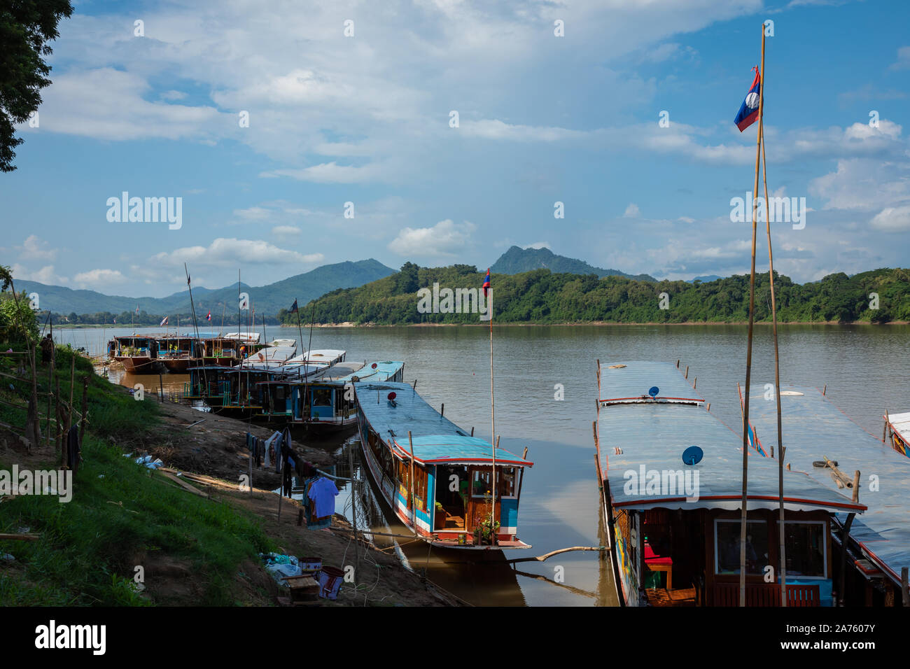 Traditional Long Boat on the Mekong River and mountains view in Luang ...