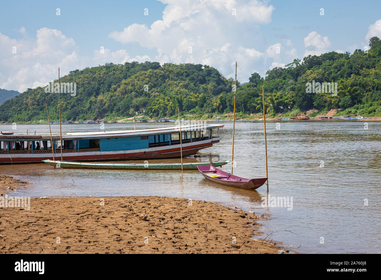 Traditional Long Boat on the Mekong River and mountains view in Luang ...