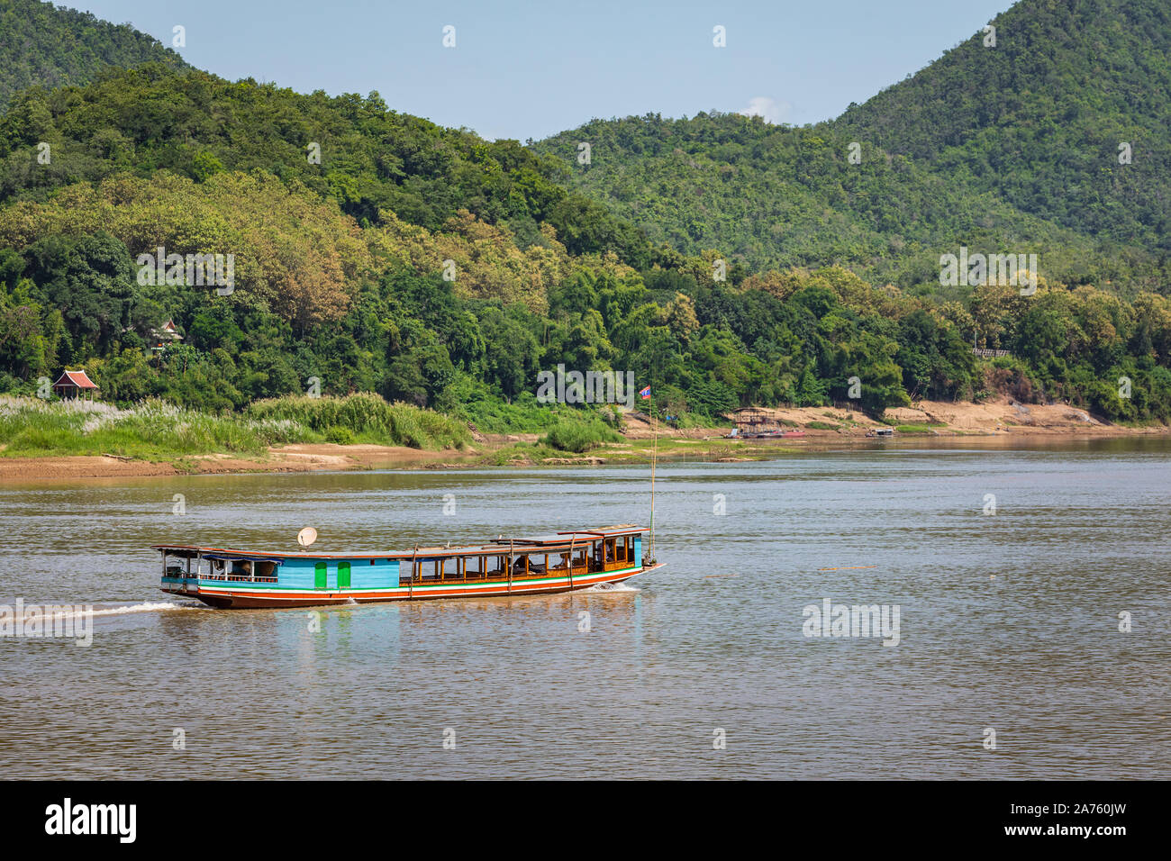 Traditional Long Boat on the Mekong River and mountains view in Luang ...