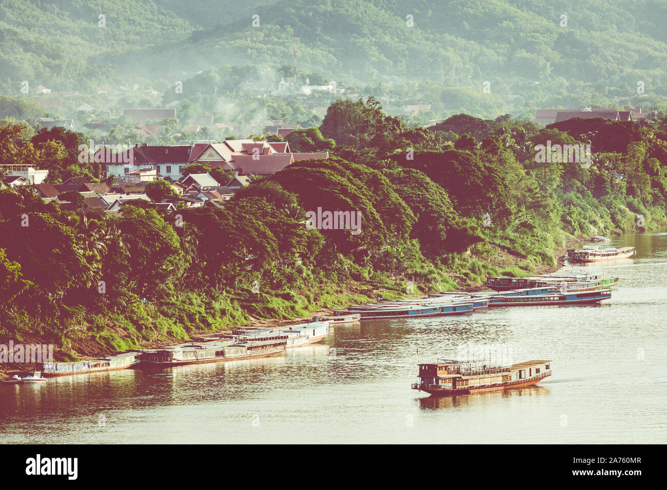 Traditional Long Boat on the Mekong River and mountains view in Luang ...