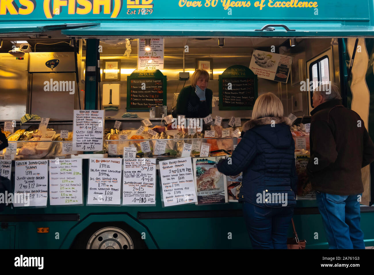 A couple buying buying from Carricks Mobile Fish van with its ...