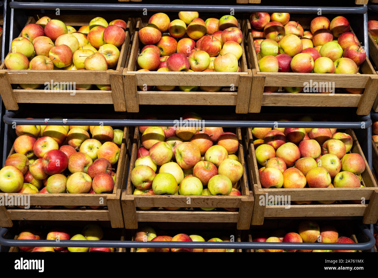 Supermarket counter with wooden boxes full of transparent red and green ...
