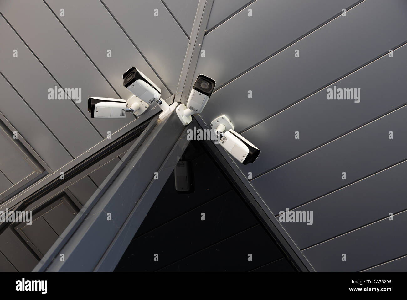 Bottom view of four modern white surveillance cameras Stock Photo - Alamy
