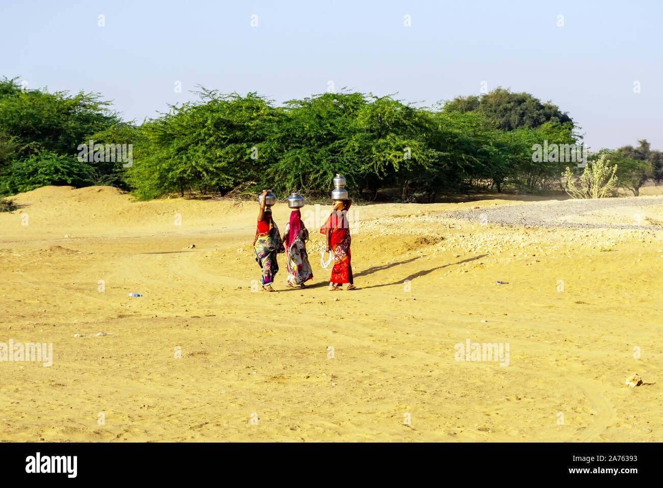 Jaisalmer, India - February 27, 2018: Indian ladies carrying a water ...