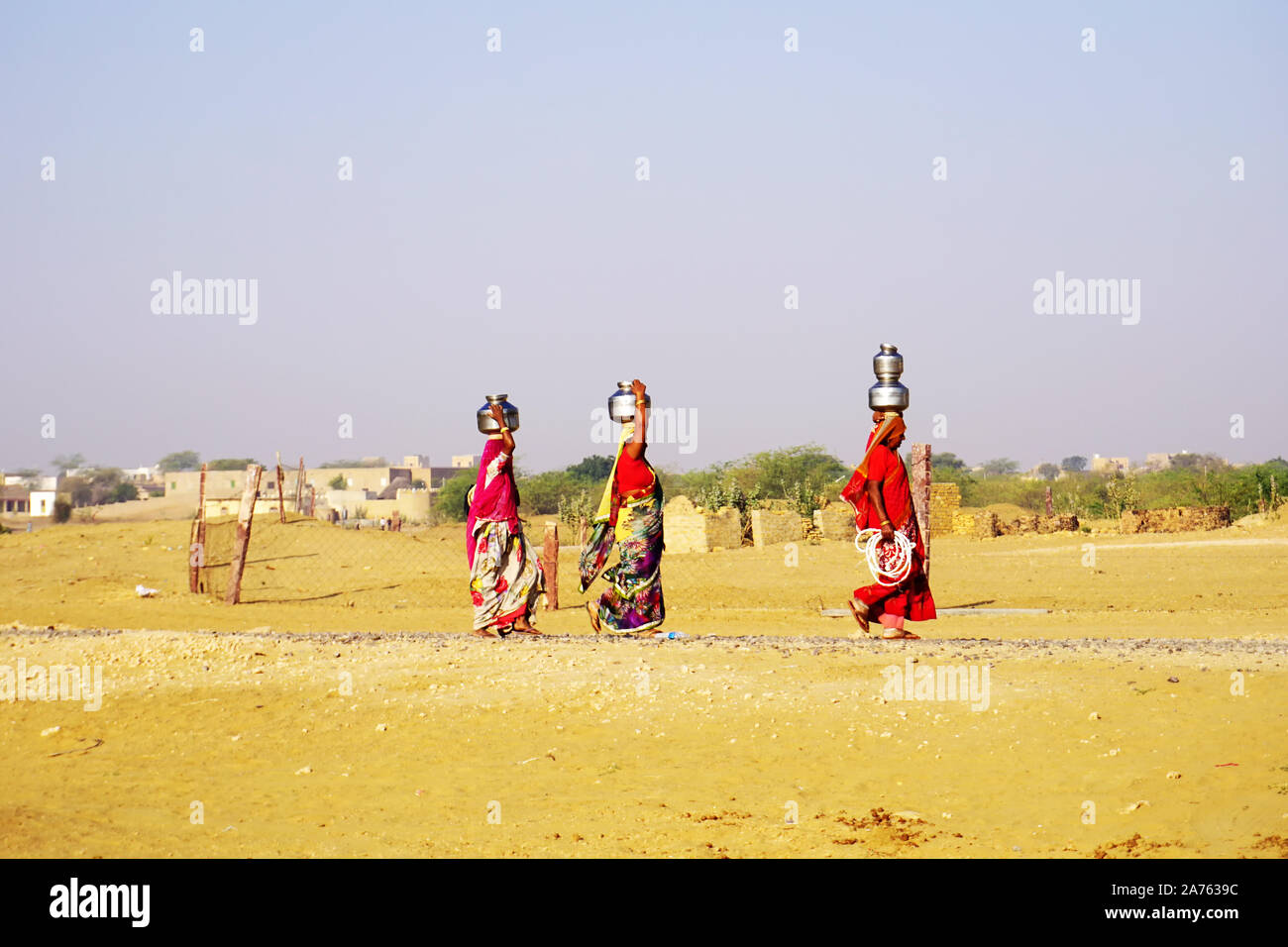 Jaisalmer, India - February 27, 2018: Indian ladies carrying a water ...