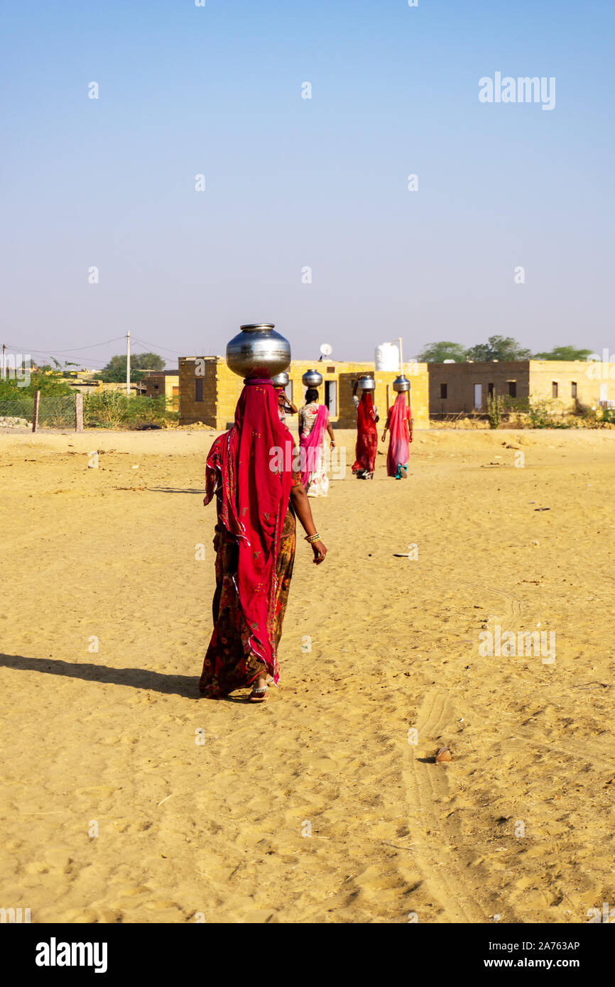 Indian ladies carrying a water bucket near Thar desert Stock Photo - Alamy