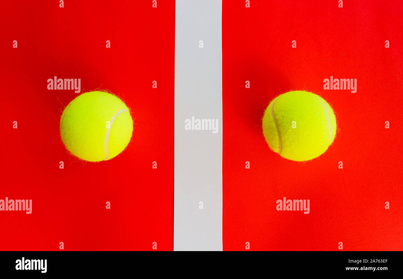 two tennis balls divided by a field line they represent a singular ...